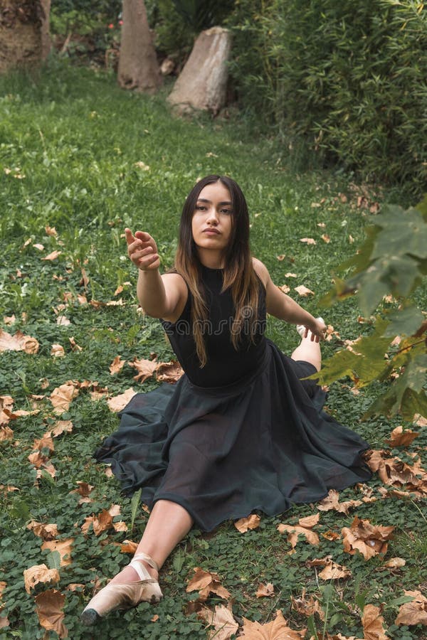 Vertical Shot of a Ballet Pose of a Ballerina Dancing in the Street in ...