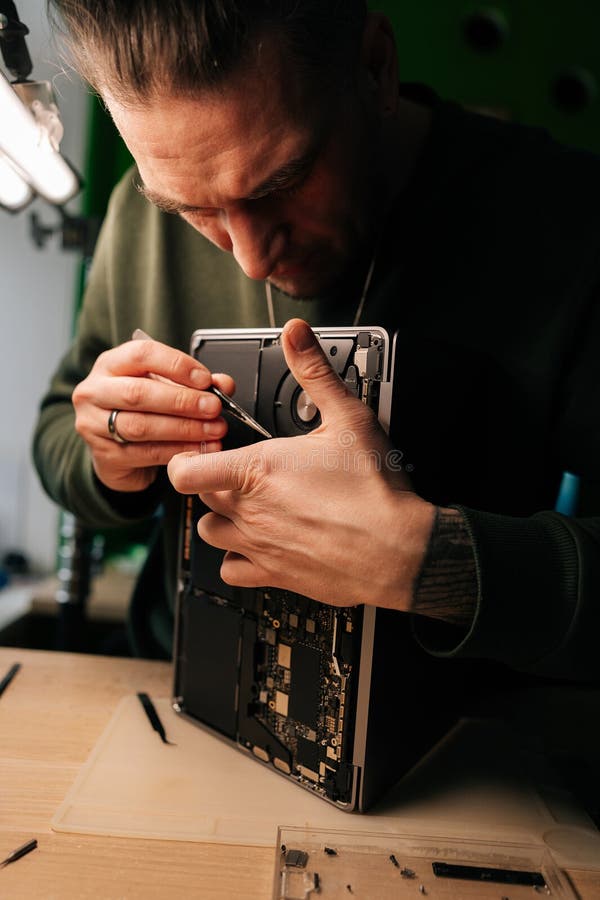Vertical Portrait of Computer Technician Inspecting Laptop Internals ...