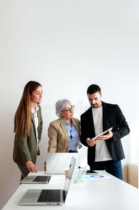 Vertical Portrait of Group of Coworkers Working Together Solving ...