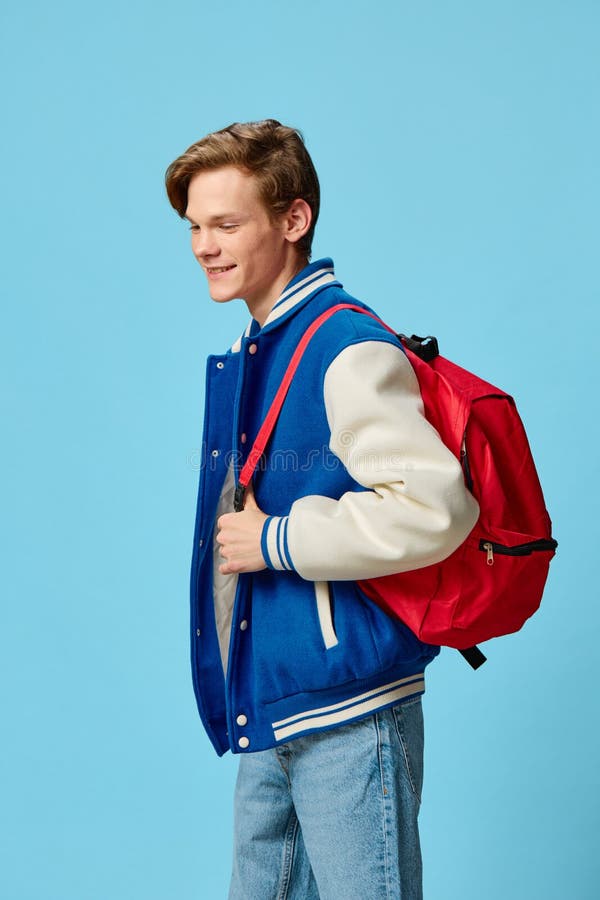 Vertical Portrait of a Handsome, Joyful Student Guy with a Red Backpack ...