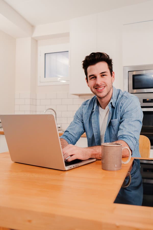 Vertical Portrait of Handsome Young Man Working Remotely from Home with ...