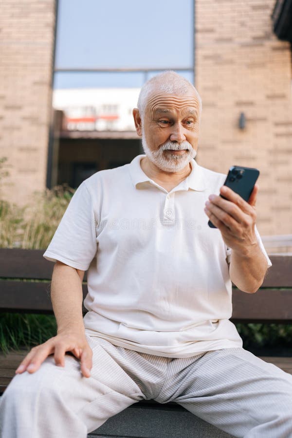 Vertical Portrait of Happy Gray-haired Elderly Man Happily Using ...