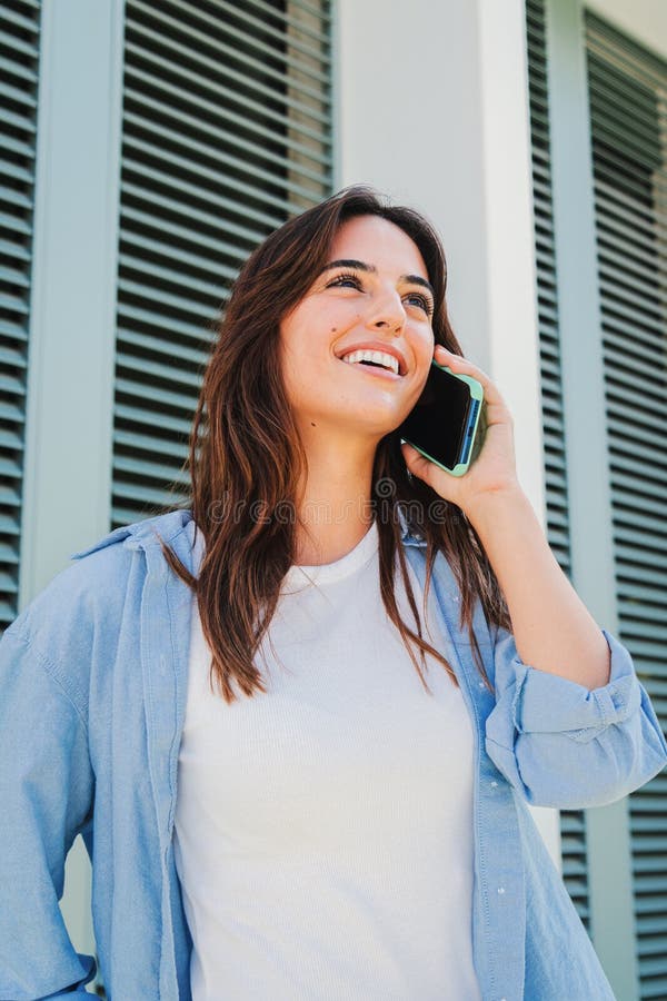 Vertical Portrait of Smiling Young Woman Using Calling Using a Mobile ...