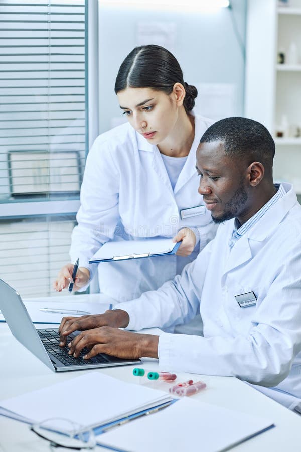 Two Scientists Using Laptop in Laboratory Stock Image - Image of ...