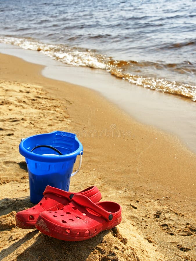 Vertical Red Shoes at the Beach Stock Photo - Image of shore, space ...