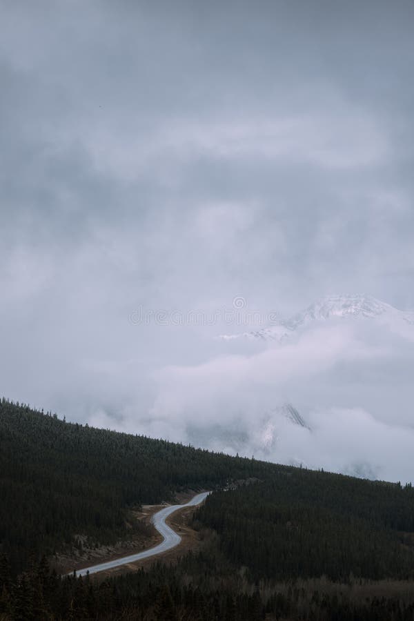 Vertical of a Road Overlooking the Mountain Under a Cloudy Sky. Stock ...