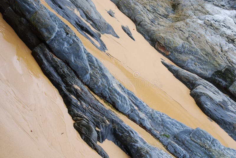 Vertical Rocks with sand stock photo. Image of color - 143952144