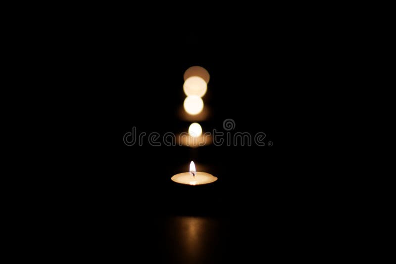 Vertical Row of Candles Burning in the Darkness Stock Photo - Image of ...