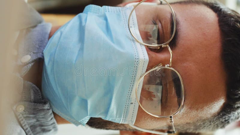 Vertical Screen: Man in Mask and Eyeglasses Reading Book in Library ...