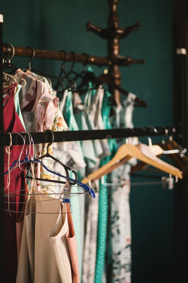 Vertical Selective Shot of Brown Clothes Hangers Hanged on a Rack with ...