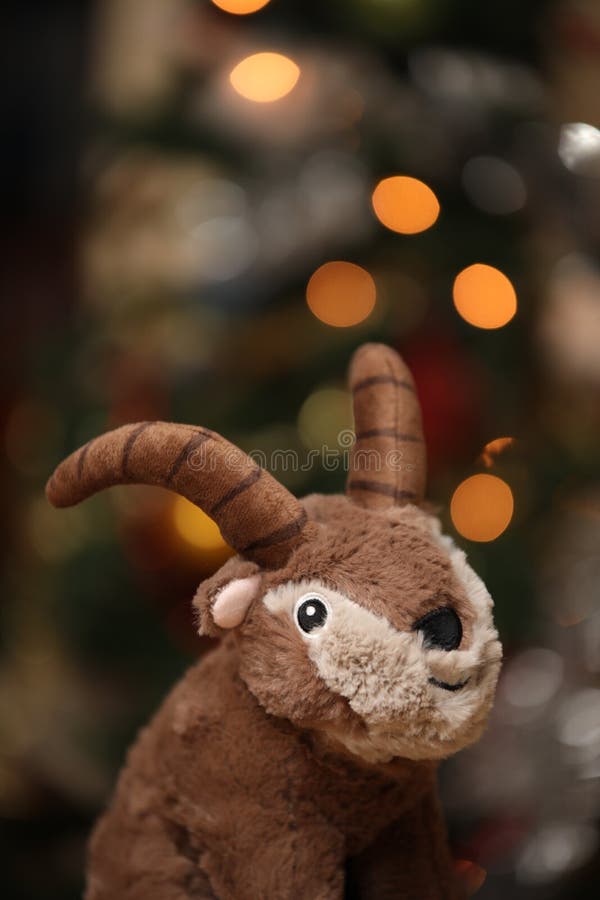 Vertical Shallow Focus of a Cute Ibex Plush Toy on Blurred Bokeh Lights ...