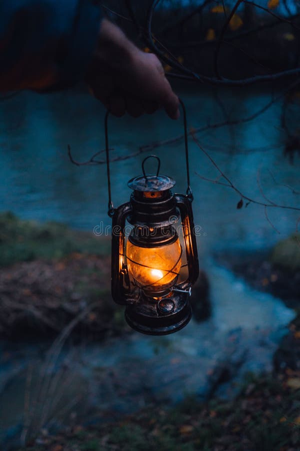 Vertical Shallow Focus Shot of a Human Hand Holding a Beautiful Lantern ...