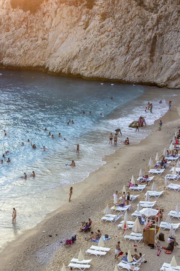 Vertical Shoot of People Enjoying the Beach with Array of Sunbeds at ...