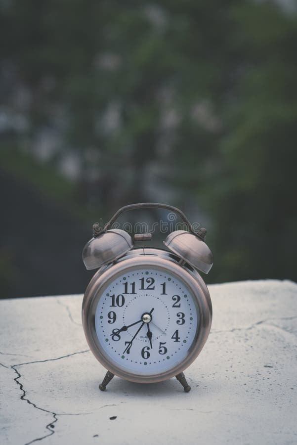 Vertical Shot of an Alarm Clock on a Cracked Stone Surface Stock Photo ...
