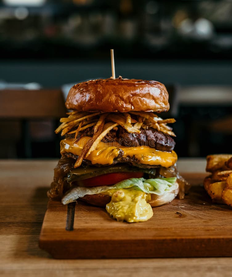 Vertical Shot of an Appetizing Double-sized Burger at a Restaurant ...