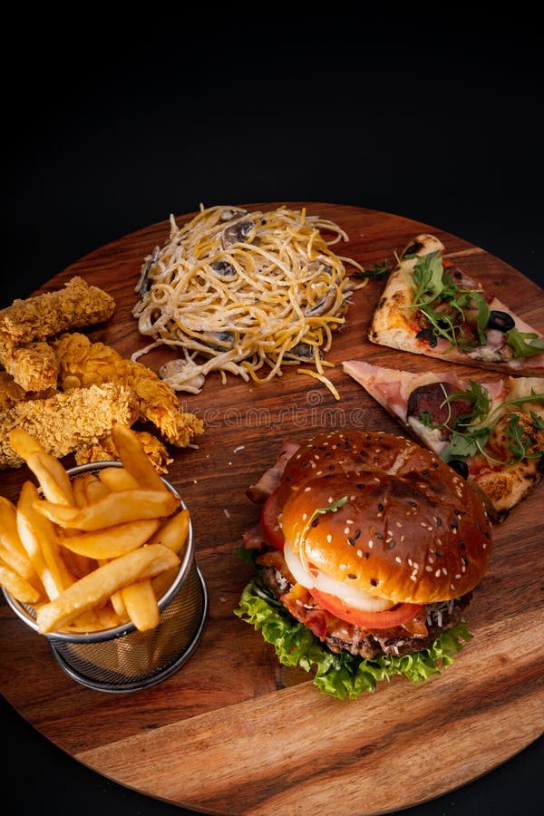 Vertical Shot of Assorted Fast Food on a Wooden Surface Stock Image ...