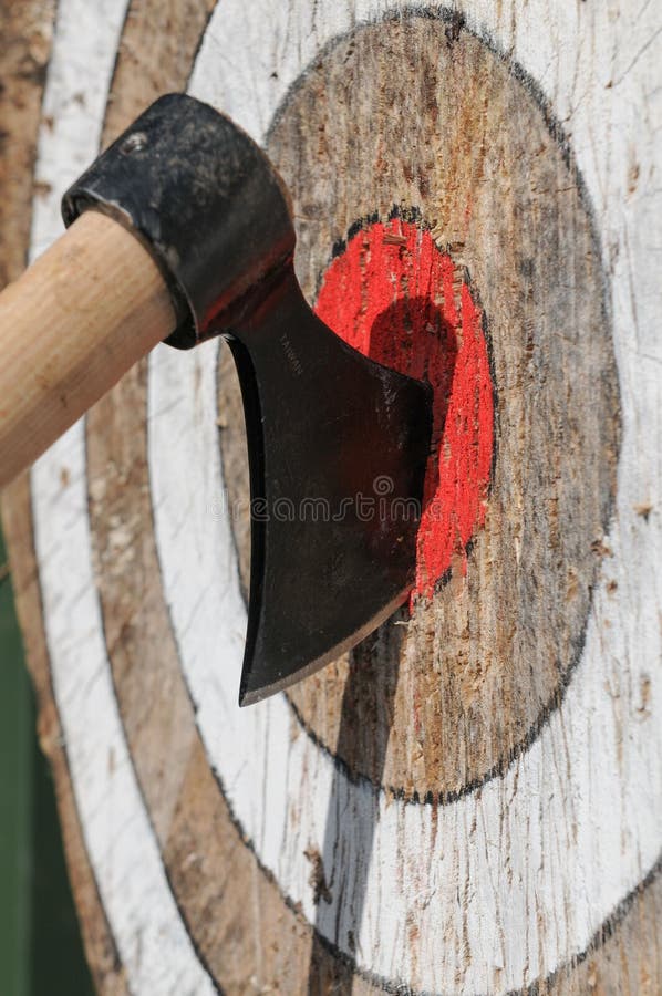 Vertical Shot of an Axe on a Red Target on a Sunny Day Stock Photo ...