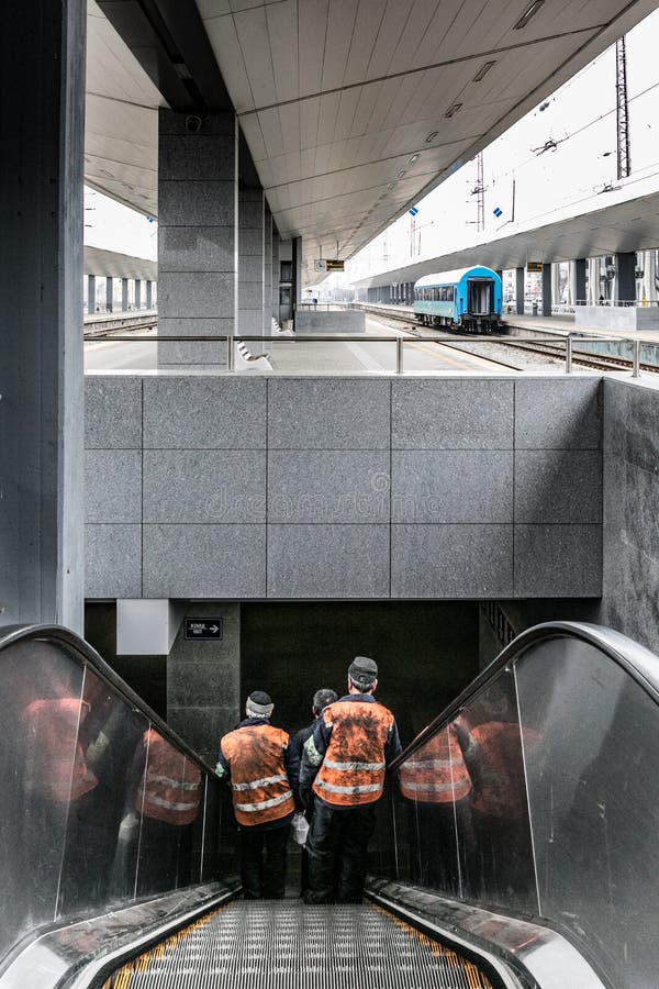 Vertical Shot of a Back View of Workers of a Train Station Going Down ...