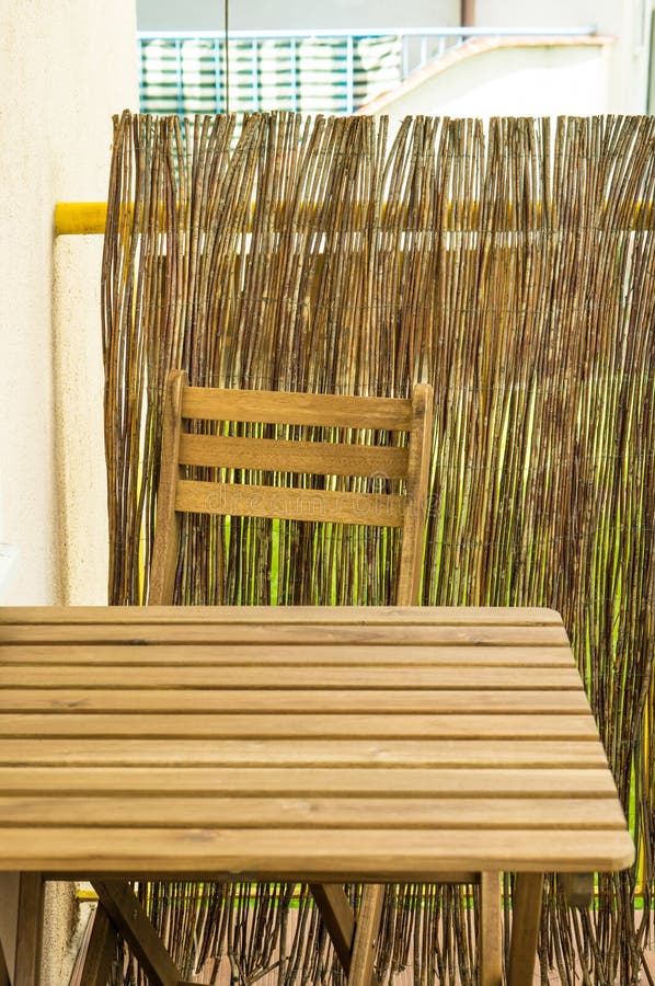 Vertical Shot of the Back of a Wooden Garden Chair Behind the Table ...