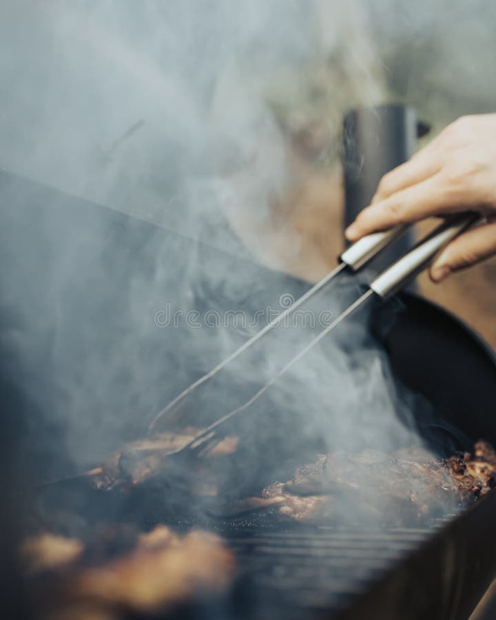 Vertical Shot of Barbecue with Smoke on the Grill Stock Photo - Image ...
