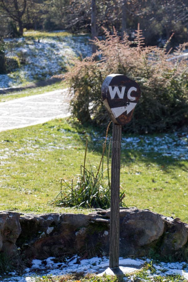 Vertical Shot of a Bathroom Sign on the Side of the Road Stock Image ...