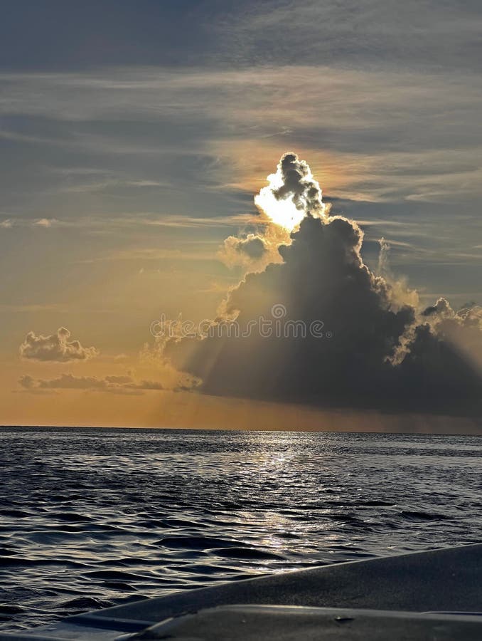 Vertical Shot of a Beach with the Sun Behind it during the Sunset with ...