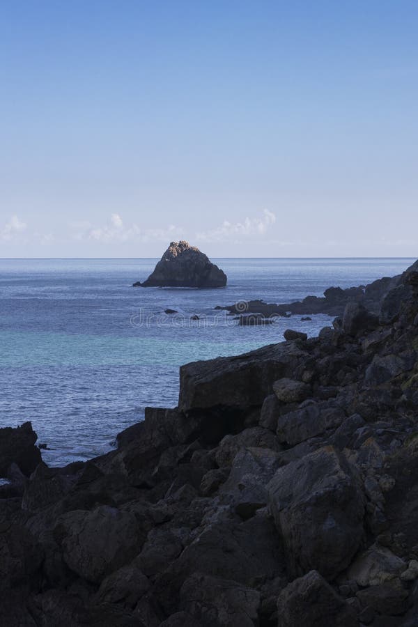 Vertical Shot of a Beautiful Rocks Alongside and Inside the Ocean Under ...