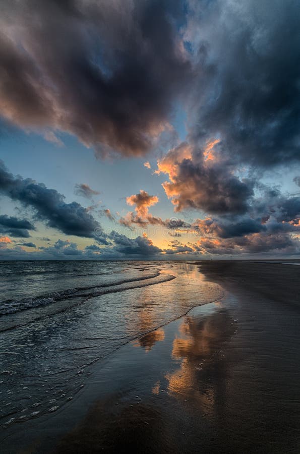 Vertical Shot of a Beautiful Sunset Reflecting in the Ocean Creating ...
