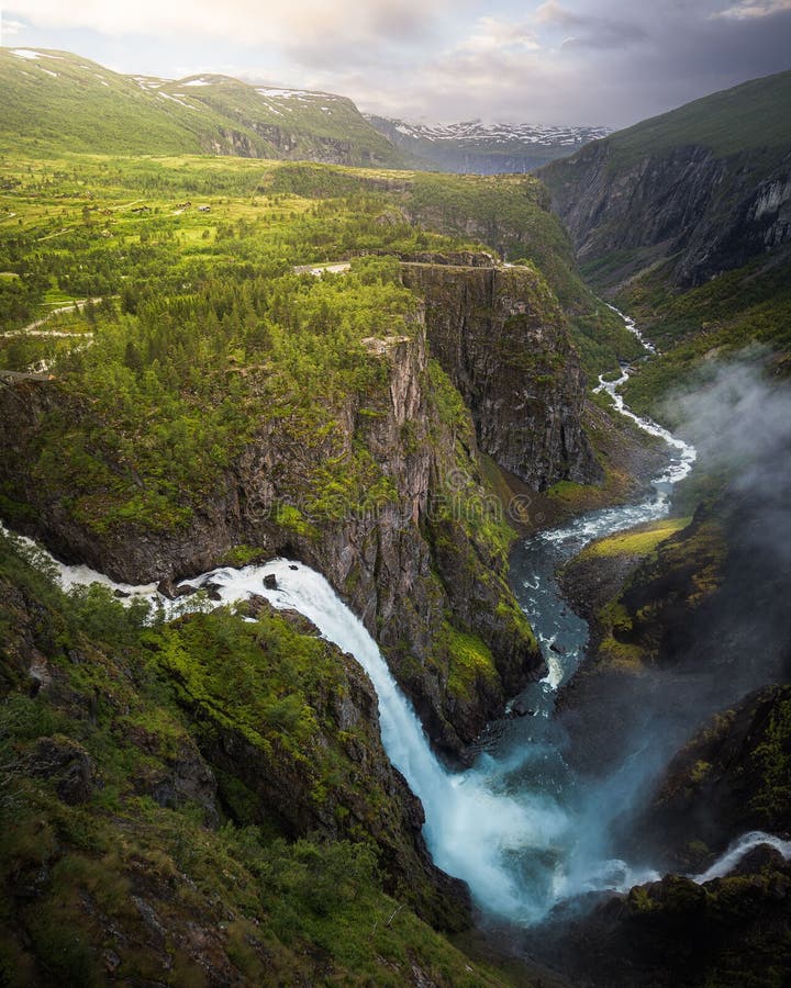 Vertical Shot of a Beautiful Waterfall Flowing through the Rocks Stock ...