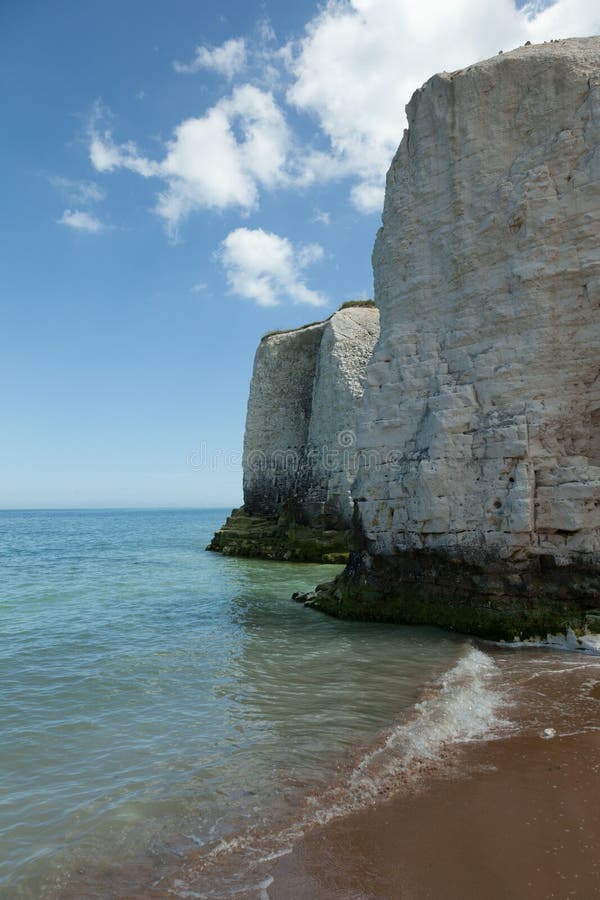 Vertical Shot of the Beautiful White Cliffs by the Sea Captured in ...