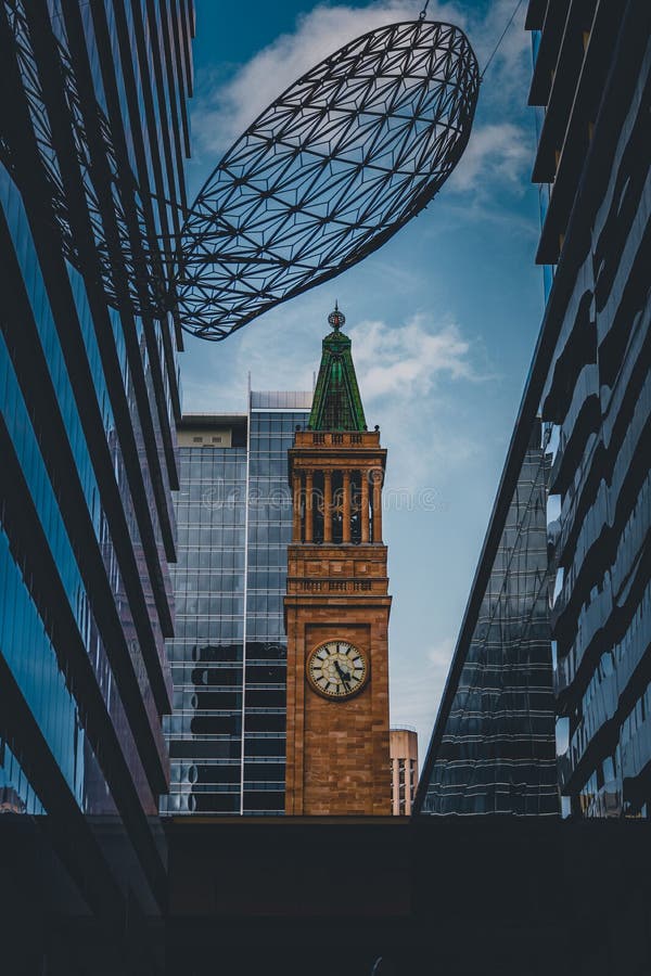 Vertical Shot of a Big Ben Clock Tower through Telstra One Building ...