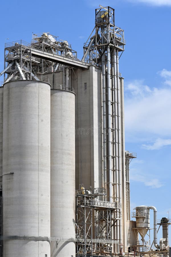 Vertical Shot of a Big Industrial Factory Under a Blue Sky Stock Photo ...