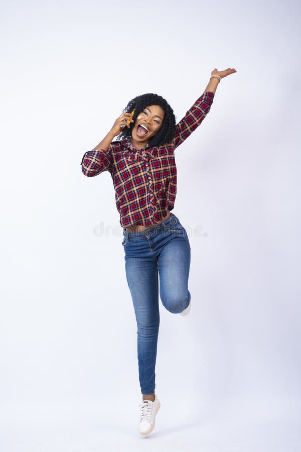 Vertical Shot of a Black Female Making a Phone Call Jumping in ...