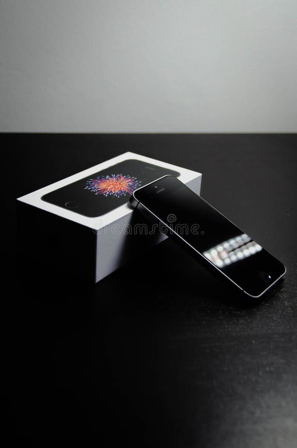 Vertical Shot of a Black IPhone SE (2016) Leaning on Its Box on a Black ...