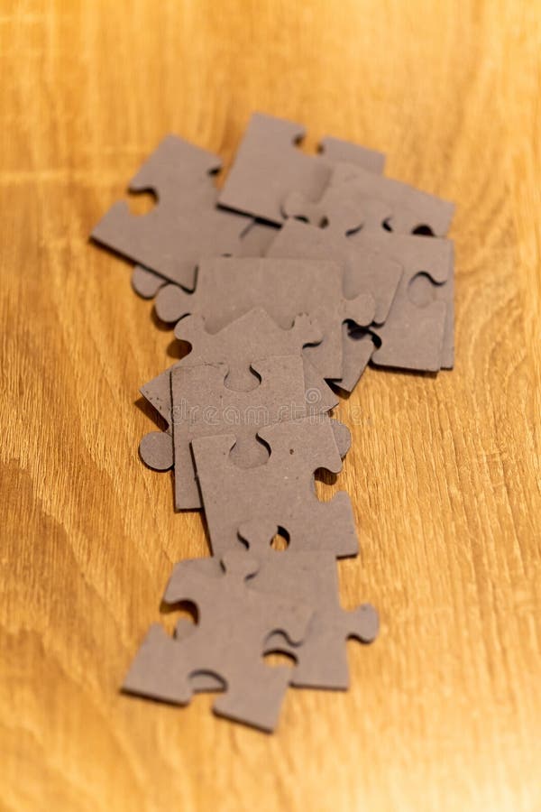Vertical Shot of Blank Puzzle Pieces on a Wooden Surface Stock Image ...
