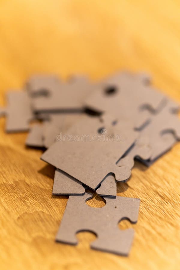 Vertical Shot of Blank Puzzle Pieces on a Wooden Surface Stock Photo ...