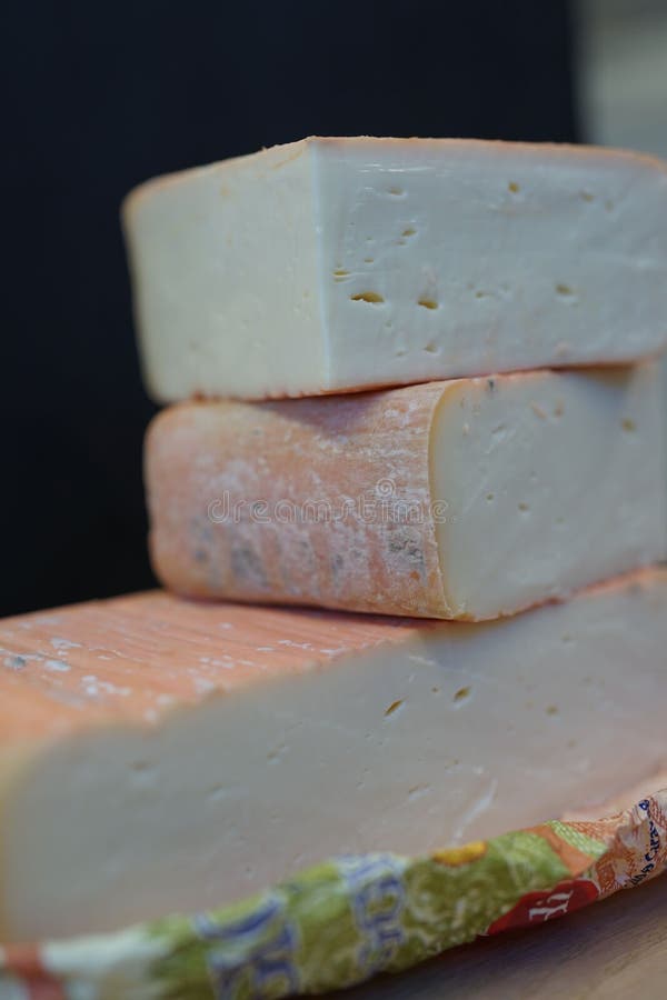 Vertical Shot of Blocks of Cheese on a Table Stock Photo - Image of ...