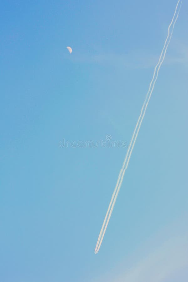 Vertical Shot of the Blue Beautiful Sky with Airplane Engine Trails and ...