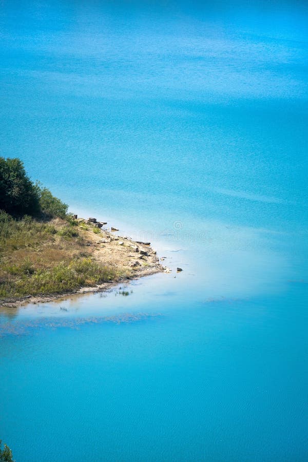 Vertical Shot of a Blue Sea with a Part of a Land Stock Image - Image ...