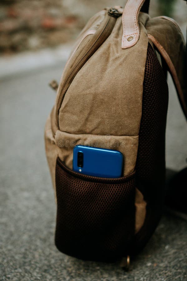 Vertical Shot of a Blue Smartphone in the Side Pocket of a Backpack on ...
