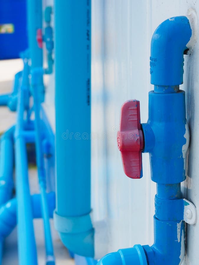Vertical Shot of Blue Water Pipes and Red Valve Stock Image - Image of ...