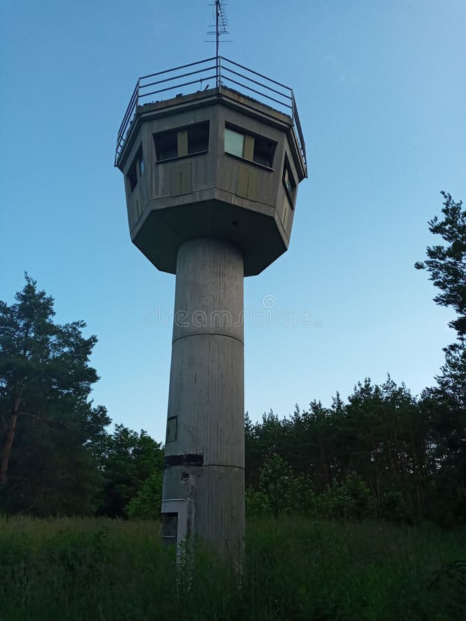 Vertical Shot of the Border Guard Tower on Grass Fields Under Blue Sky ...