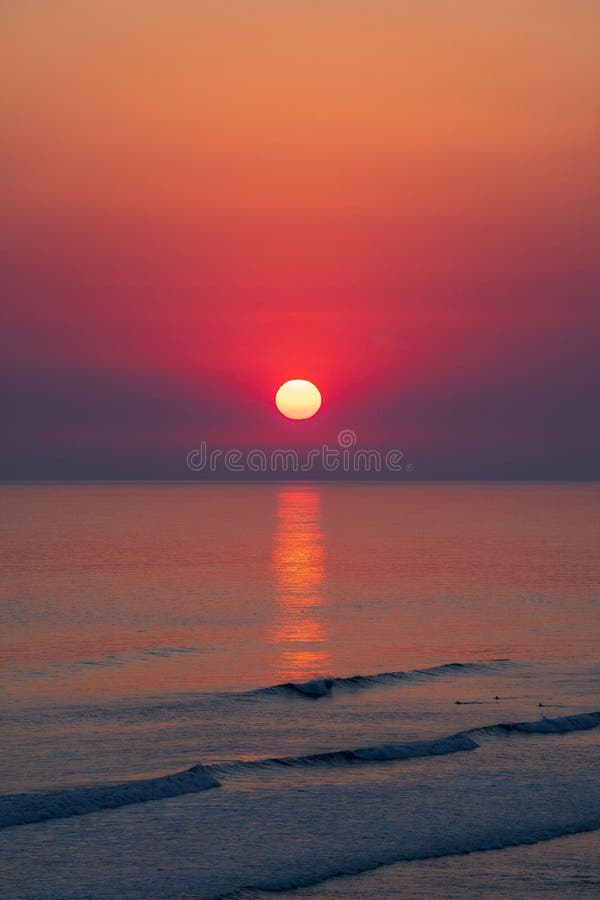 Vertical Shot of the Breathtaking Red Sunset Over the Sea in the ...
