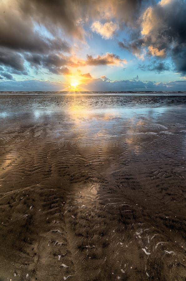 Vertical Shot of the Breathtaking Sunrise Reflecting in the Sea Under ...
