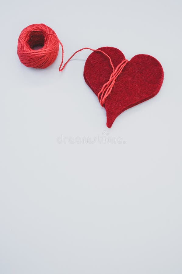 Vertical Shot of a Bright Red Yarn with Threads Wrapped Around a Red ...