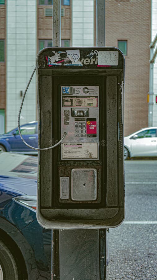 Vertical Shot of a Broken Phone Booth Located by the Side of the Street ...