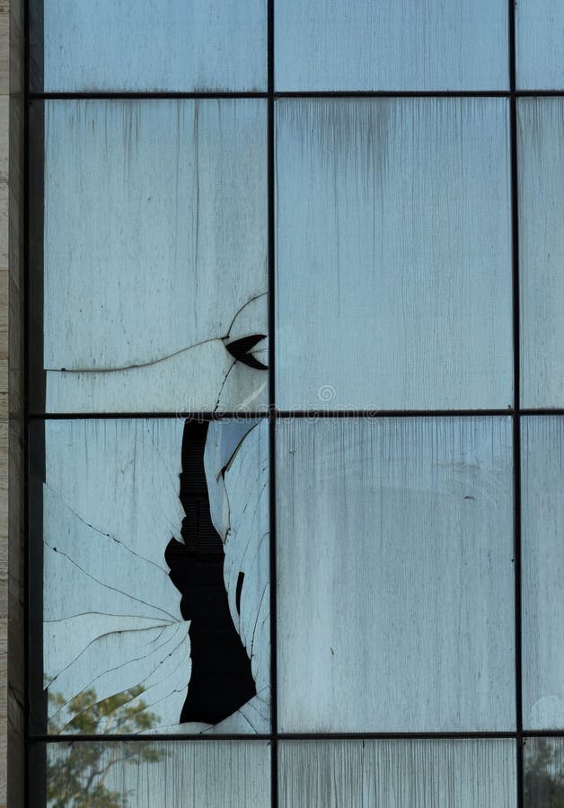 Vertical Shot of Broken Windows in a Modern Building in the Urban Area ...