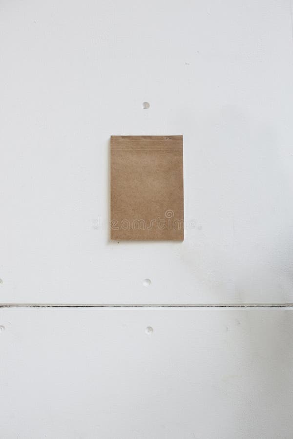 Vertical Shot of a Brown Notepad on a White Wall Stock Image - Image of ...