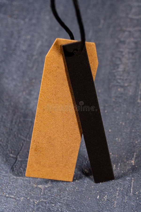 Vertical Shot of a Brown Paper Tag on a String with a Thin Black Strip ...