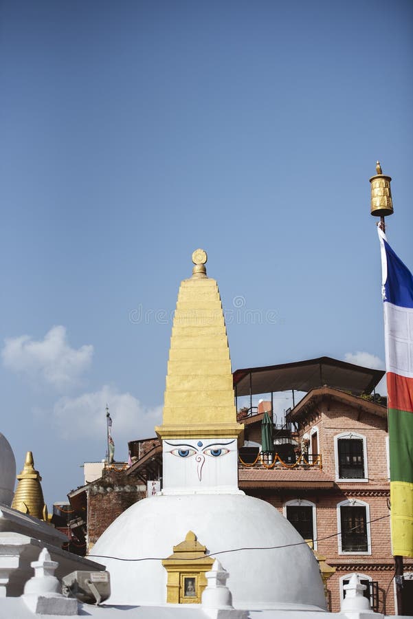 Vertical Shot of a Building with Eyes Painted on it and a Blue Sky in ...